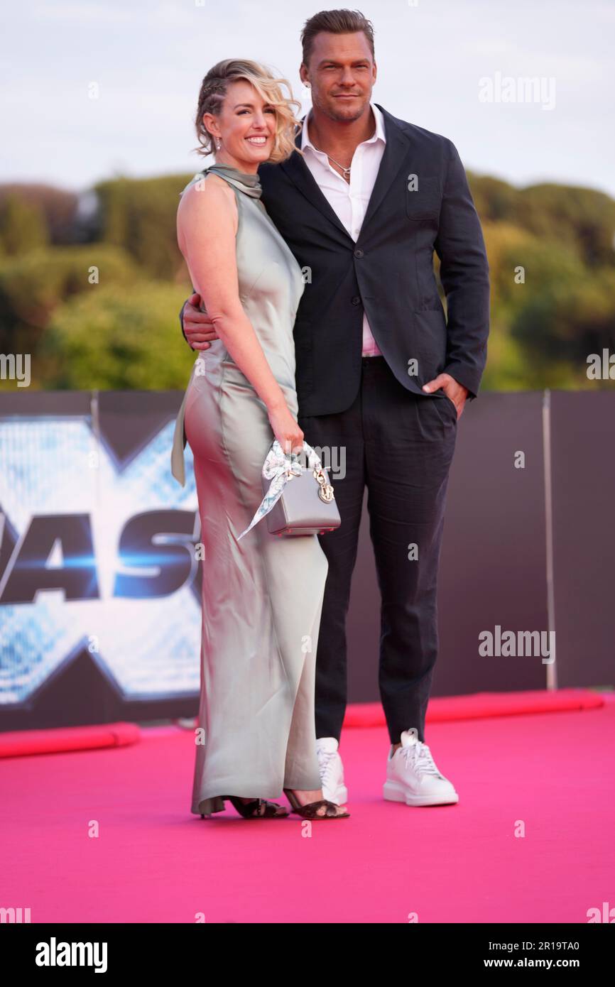 Alan Ritchson poses for photographers flanked by his wife Catherine ...