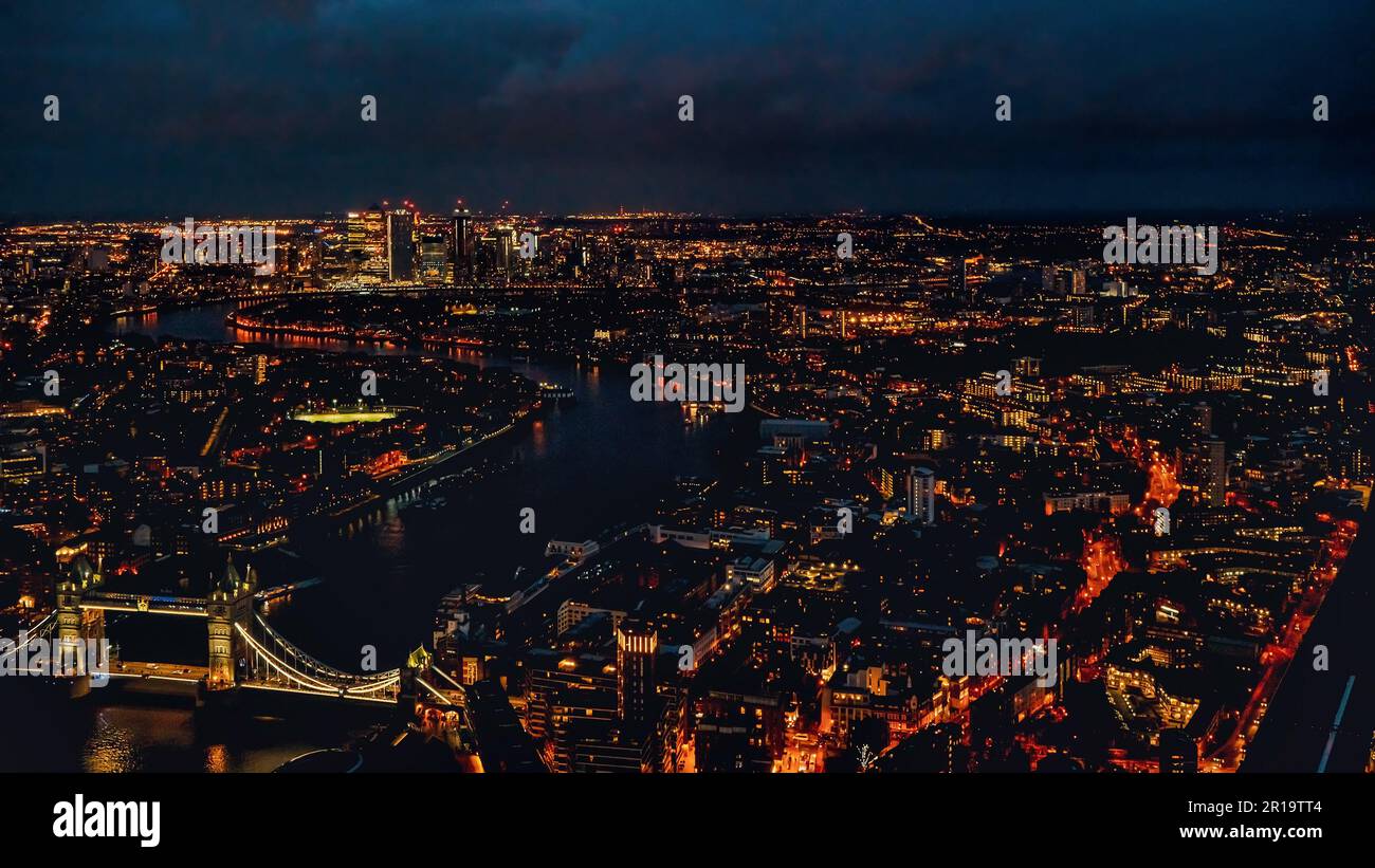 Aerial night view of west London with Tower Bridge over river Thames ...
