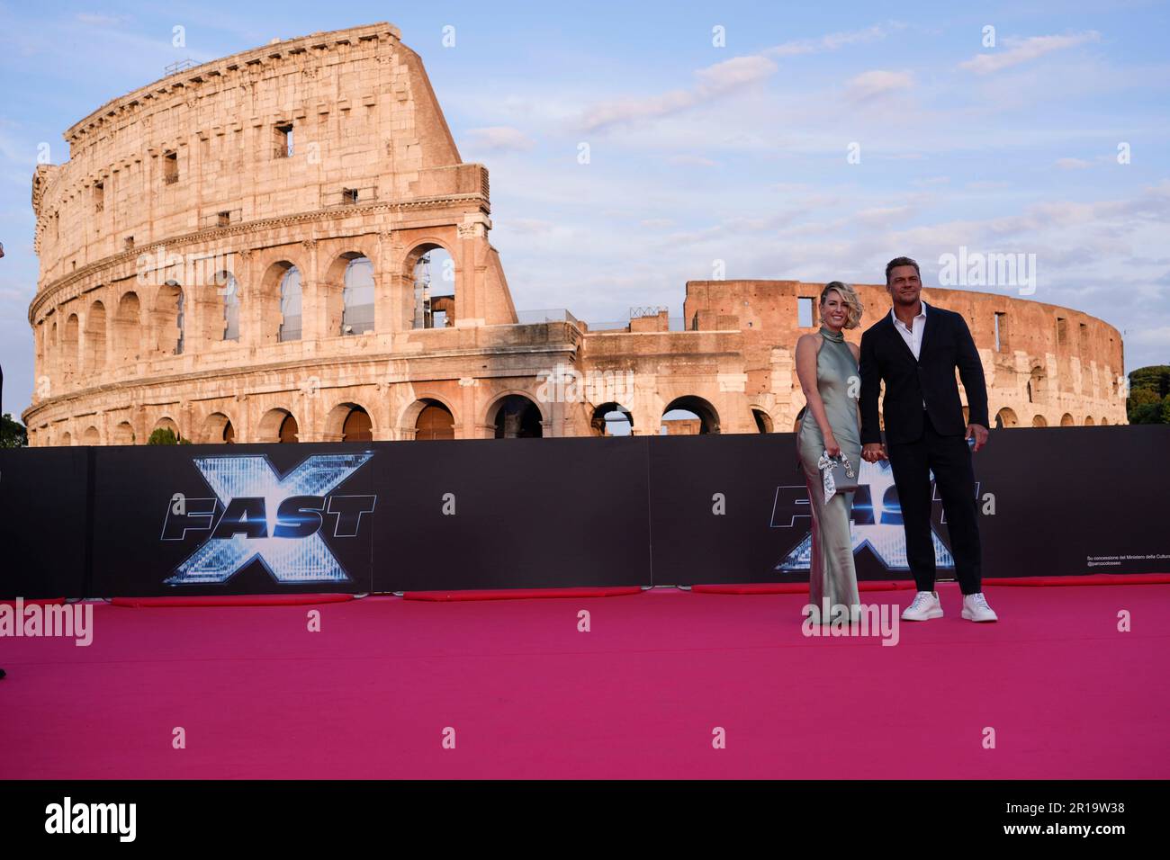 Alan Ritchson poses for photographers flanked by his wife Catherine ...