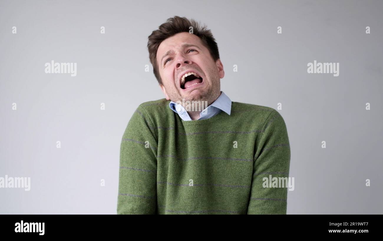 The young European man is crying from a life failure. His girlfriend ...