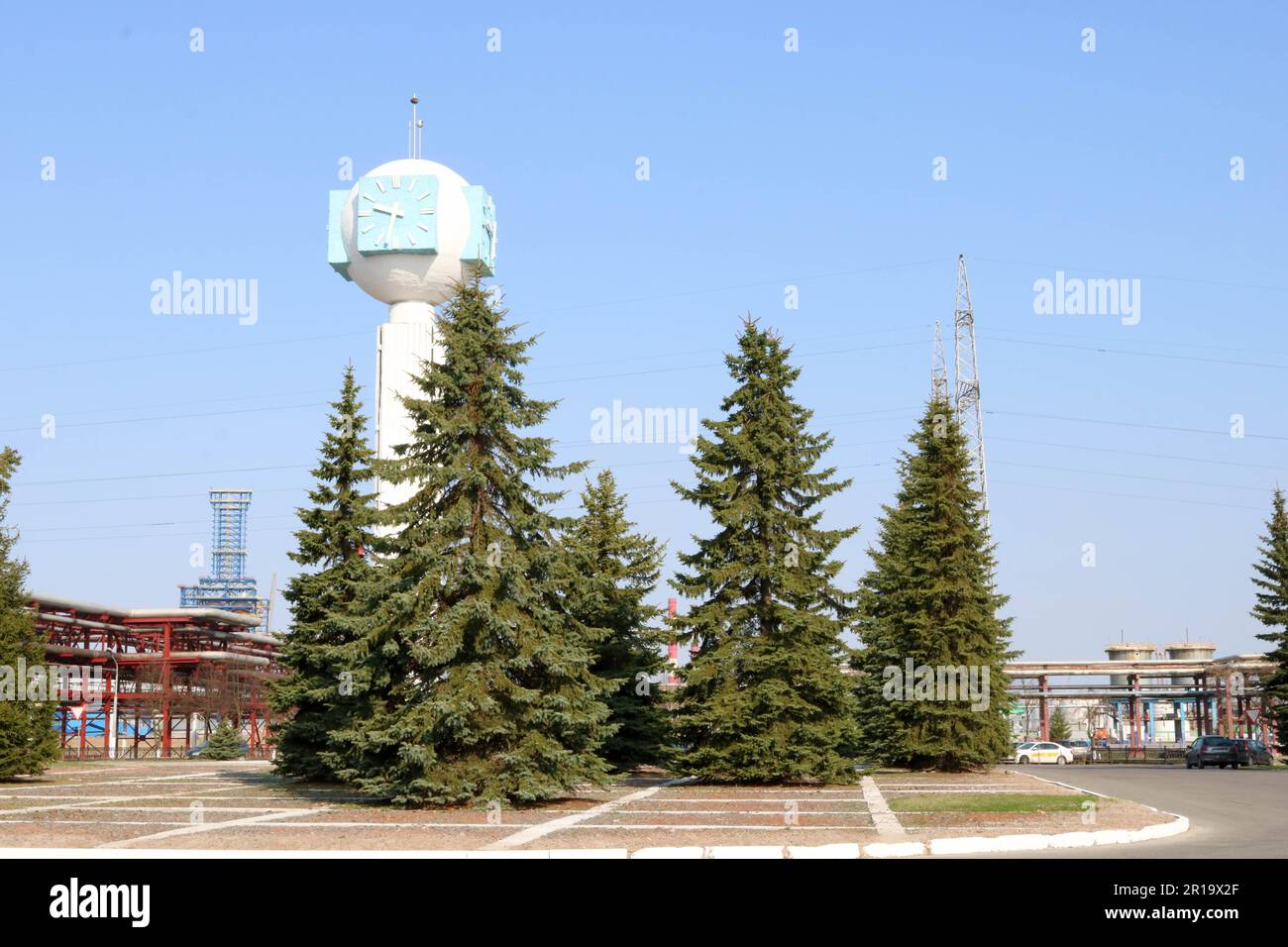 Large, tall, stone, concrete clocks with a blue dial next to the large ...
