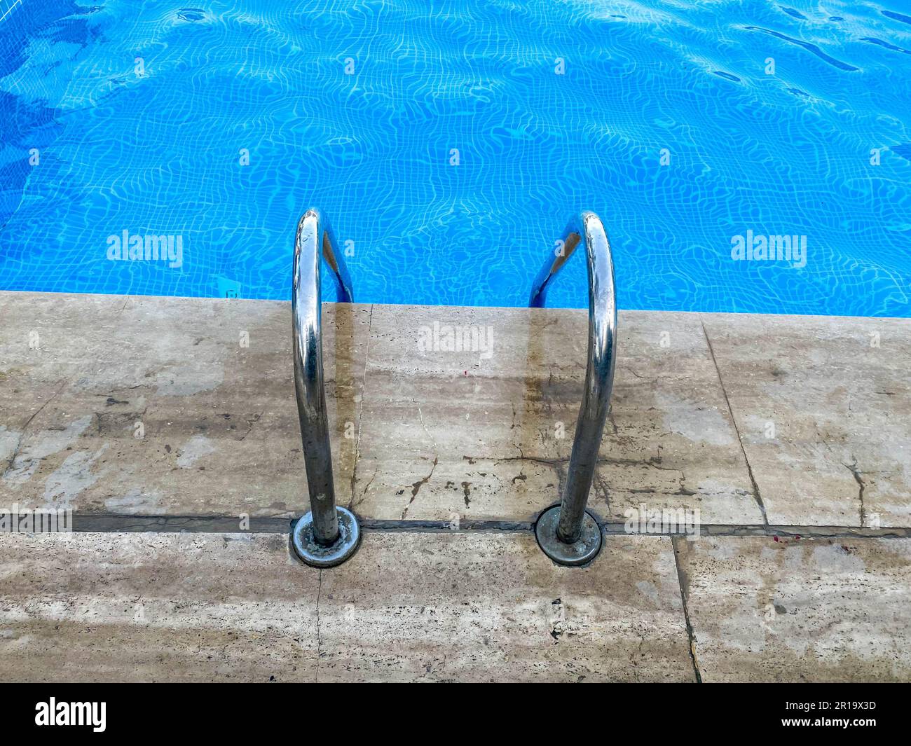 Chrome-plated metal staircase with railing to descend into the pool for ...