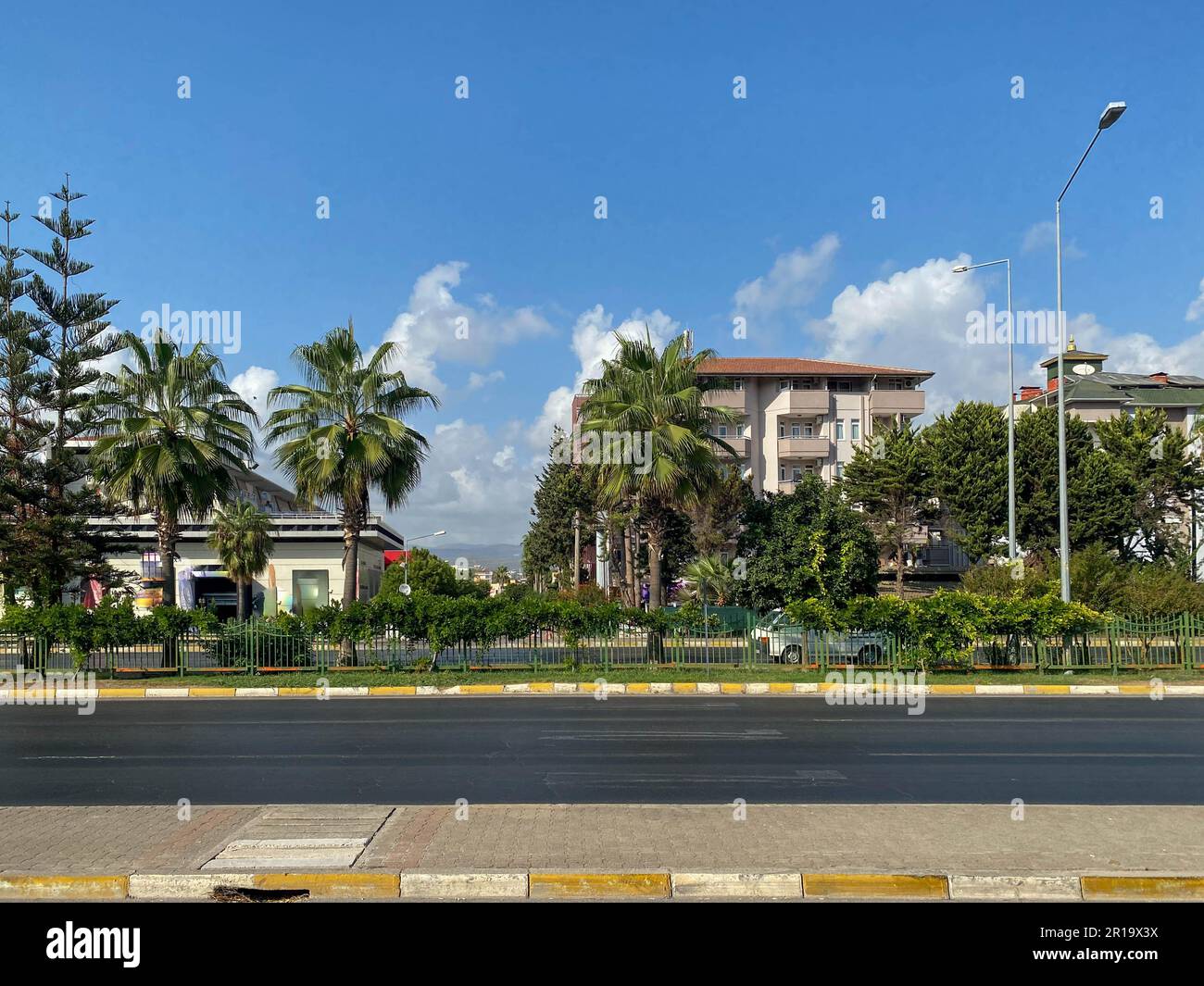 Beautiful modern buildings, architecture, road and palm trees in a warm ...