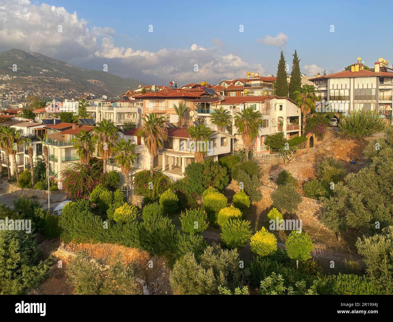 A beautiful tourist city with modern buildings on a mountain with trees ...