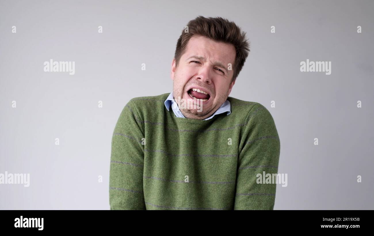 The young European man is crying from a life failure. His girlfriend ...