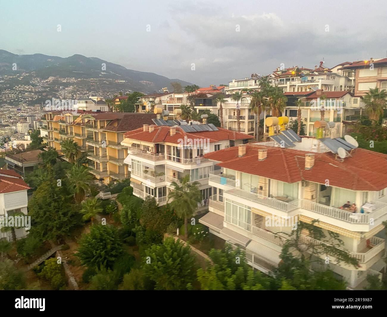 A beautiful tourist city with modern buildings on a mountain with trees ...