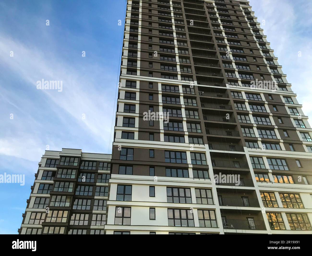 brown and white multi-storey building in the city center. there is a ...