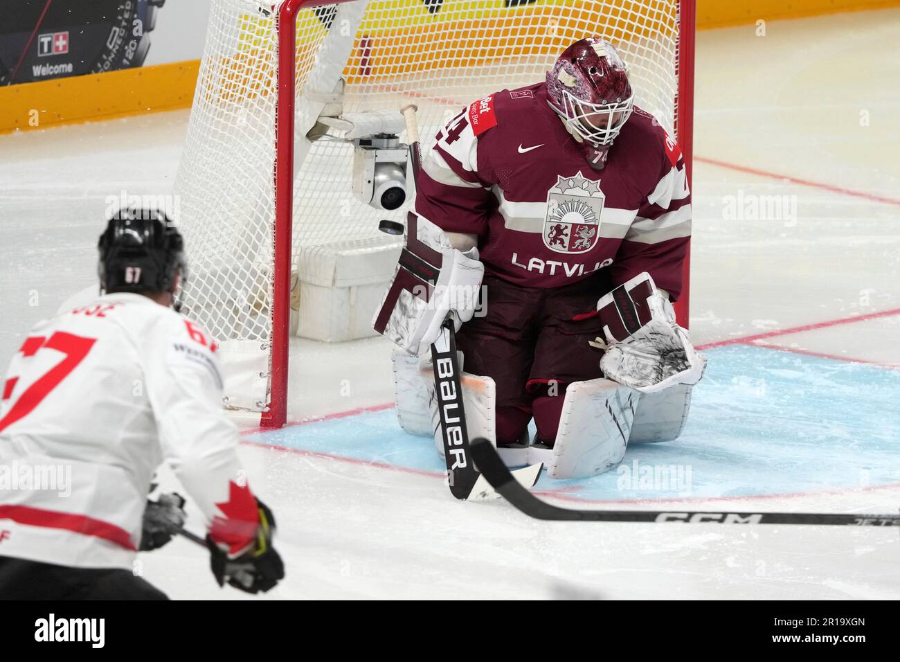 Lawson Crouse of Canada, left, scores past goalie Ivars Punnenovs of ...