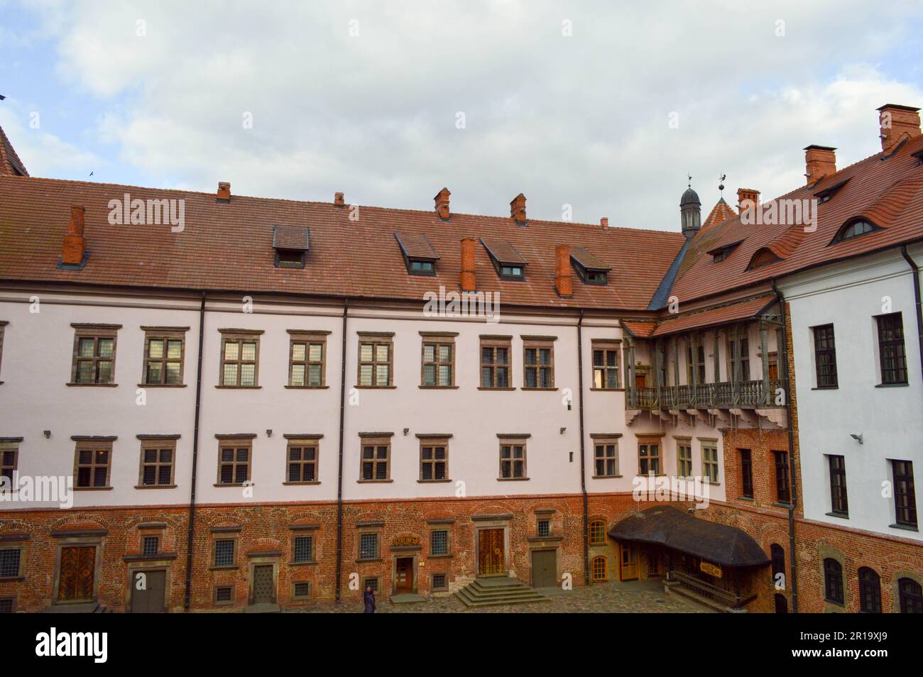 Beautiful yellow historical medieval European low-rise buildings with a ...