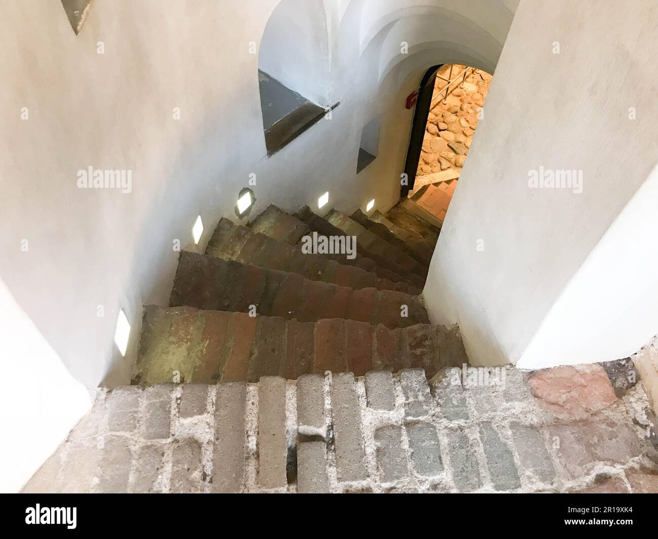 Steep stone spiral stairs going down from the steps Stock Photo - Alamy