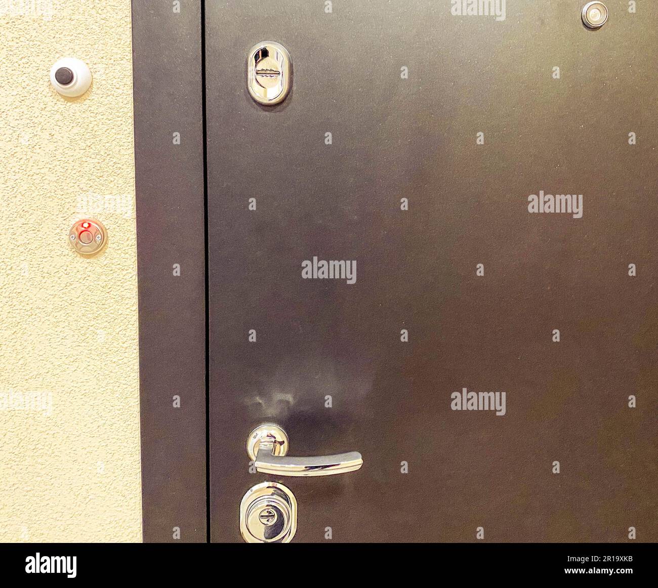 brown, metal front door. keyhole on the door. doors in a new building ...