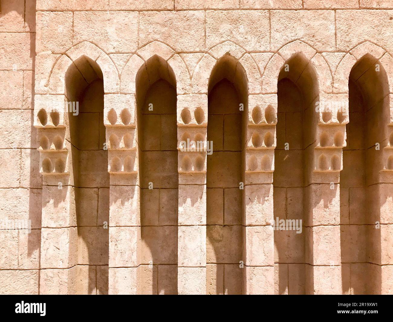 Texture of the old ancient yellow stone strong wall with arches in ...