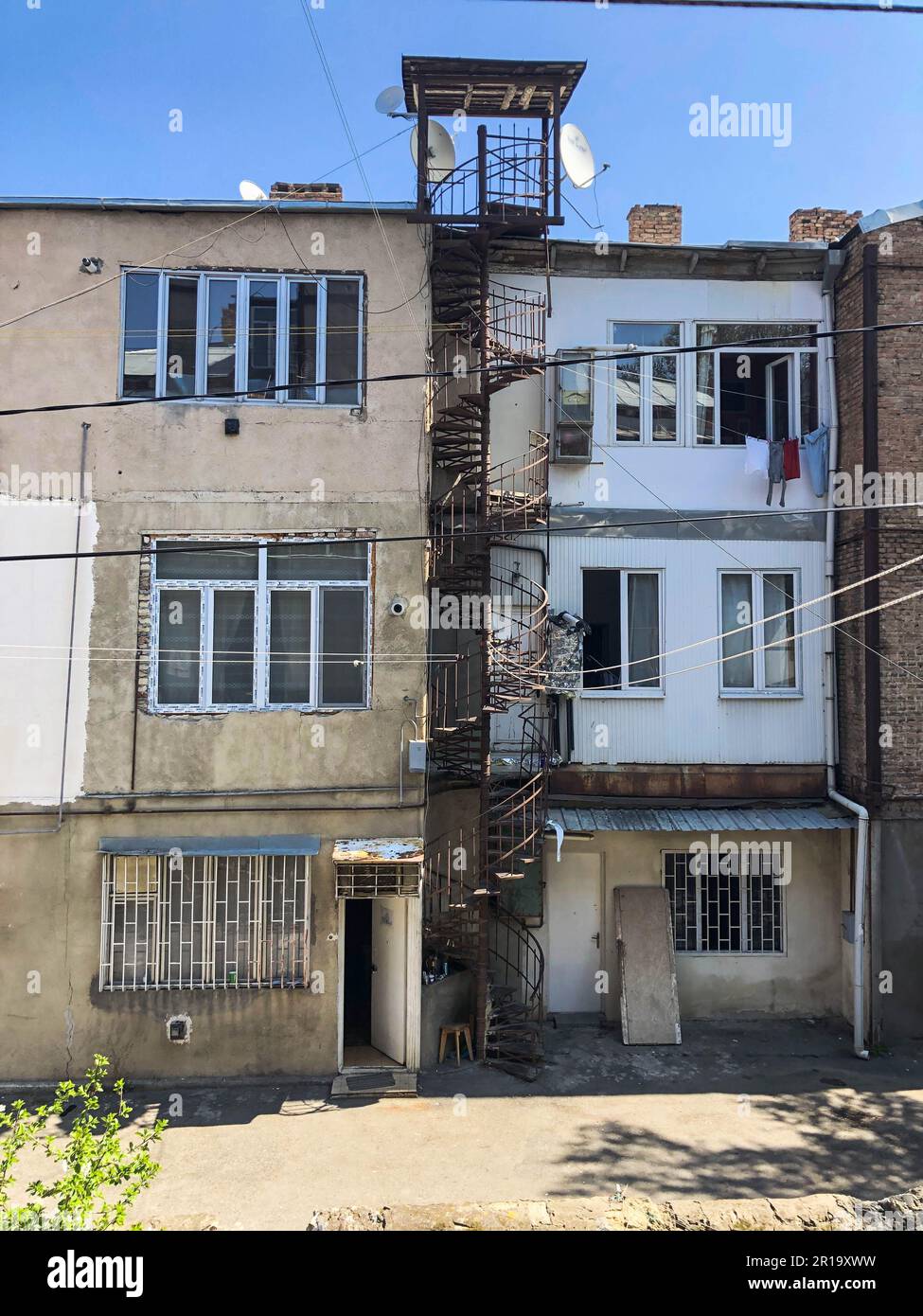 Circular screw iron small staircase on a typical three-story panel ...