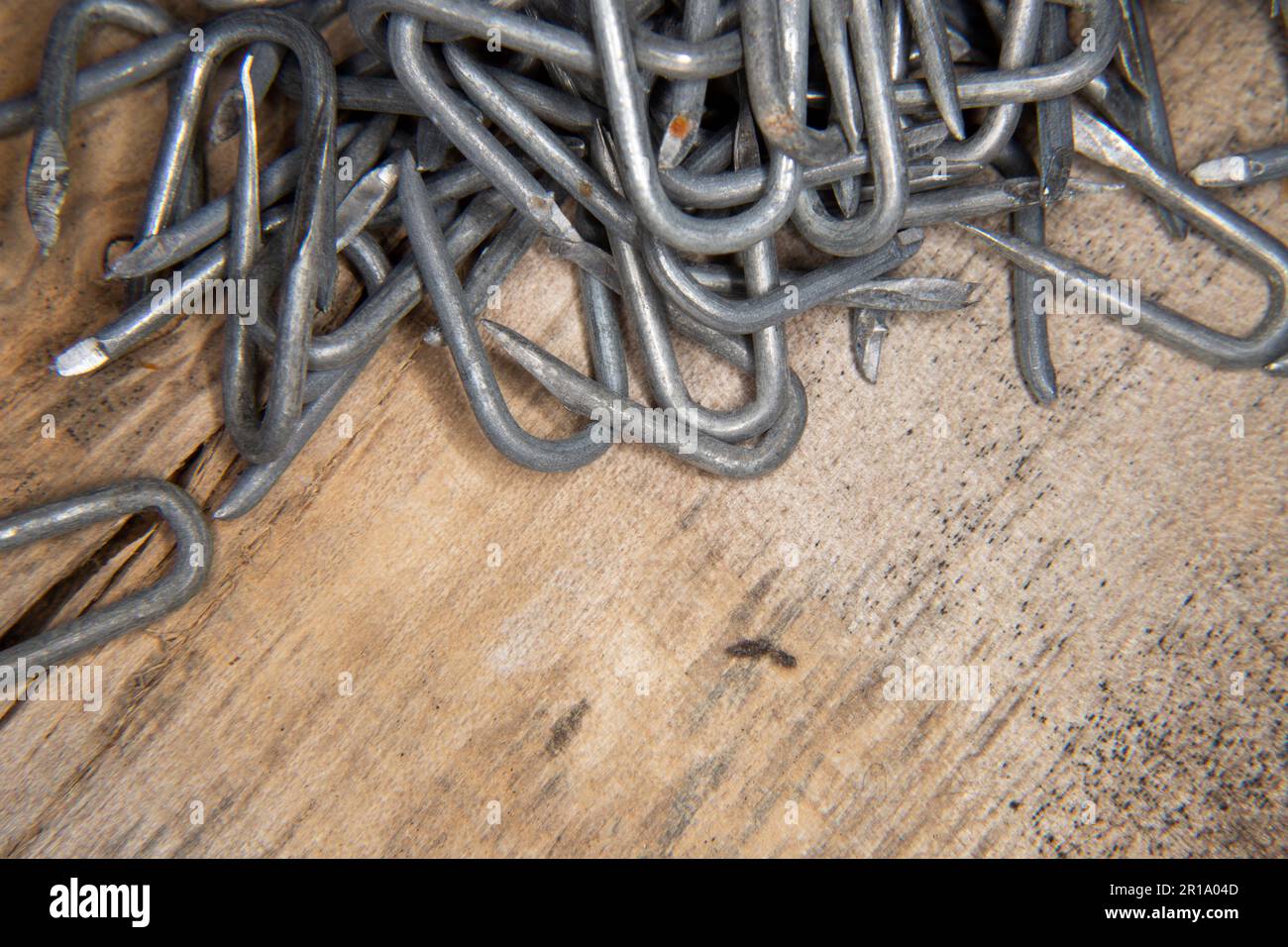 border made from pile of heavy barbed wire staples for construction and ...