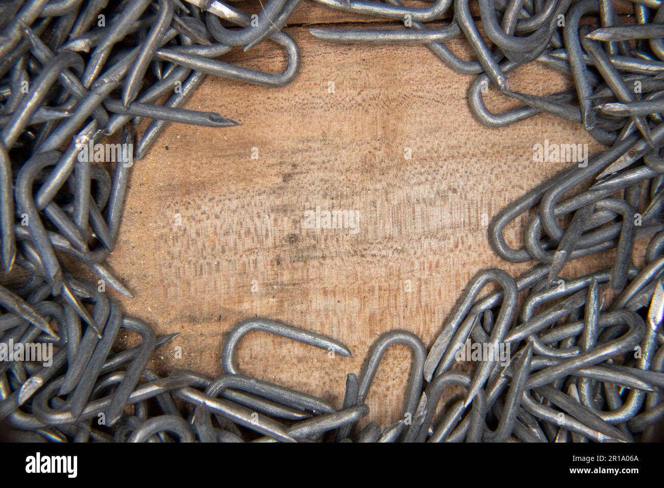 border made from pile of heavy barbed wire staples for construction and ...