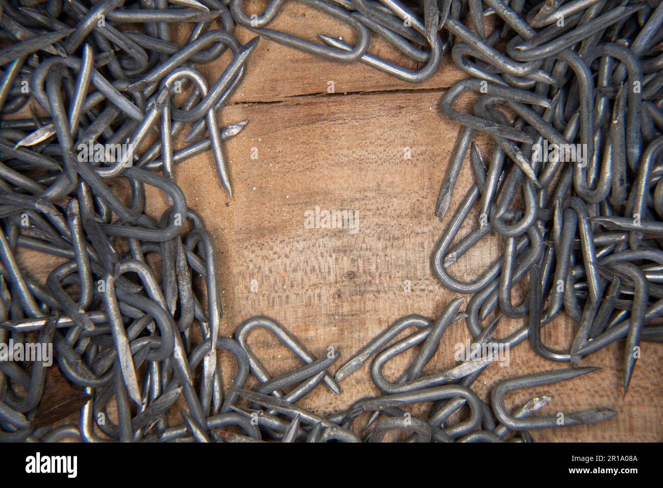 border made from pile of heavy barbed wire staples for construction and ...