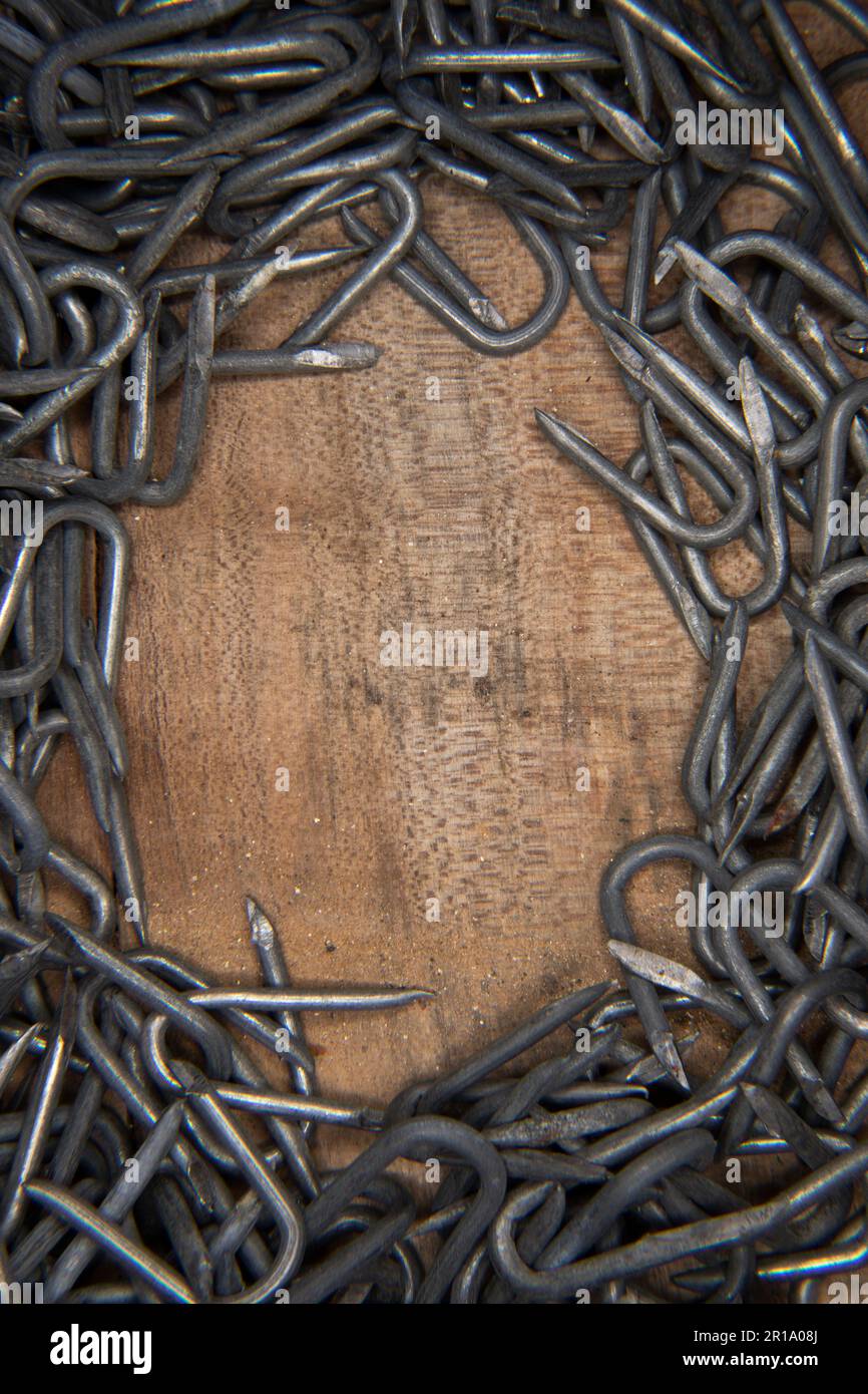 border made from pile of heavy barbed wire staples for construction and ...
