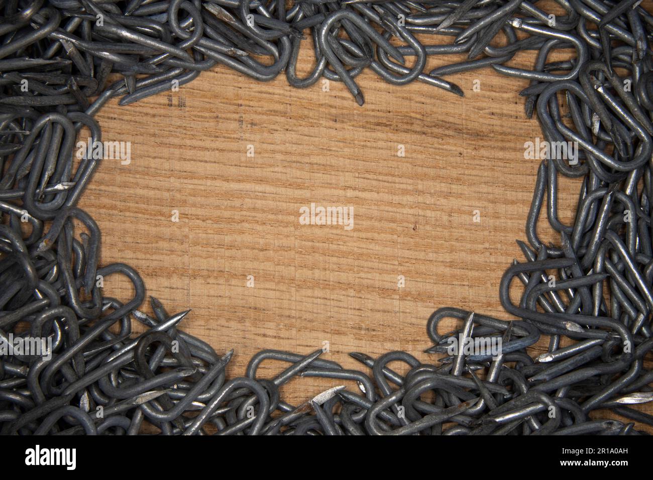 border made from pile of heavy barbed wire staples for construction and ...