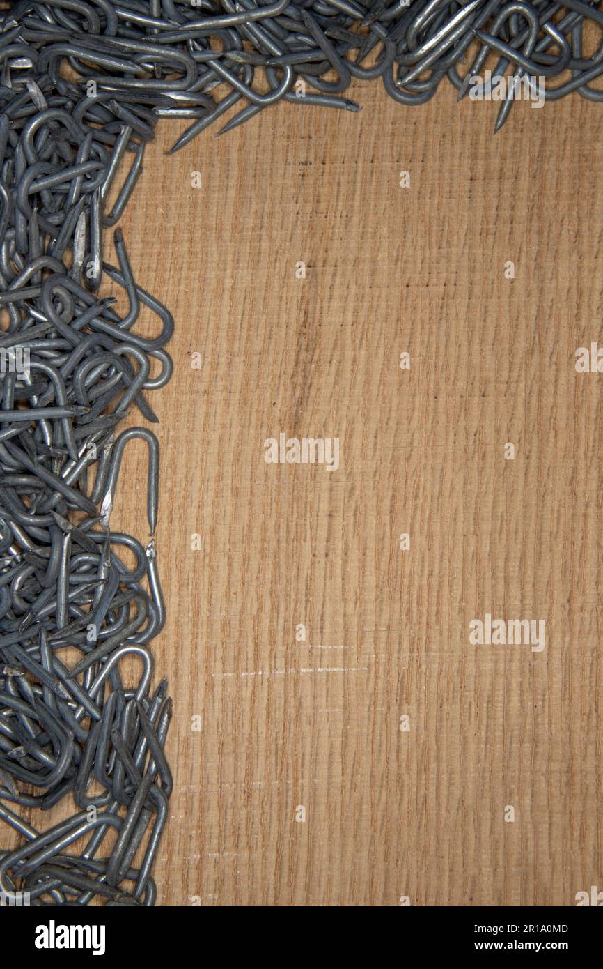 border made from pile of heavy barbed wire staples for construction and ...