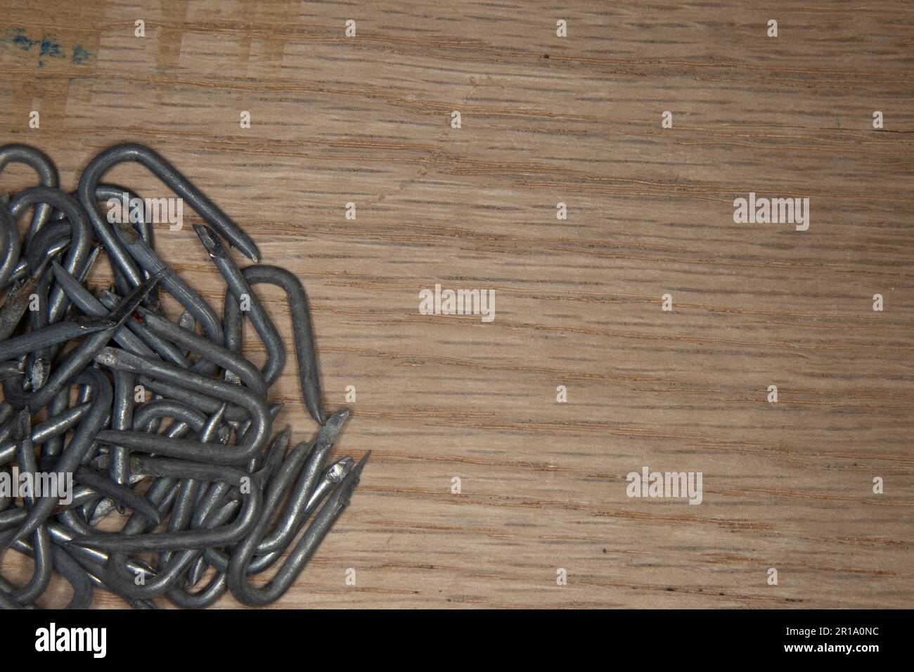 pile of heavy barbed wire staples for construction and carpentry Stock ...