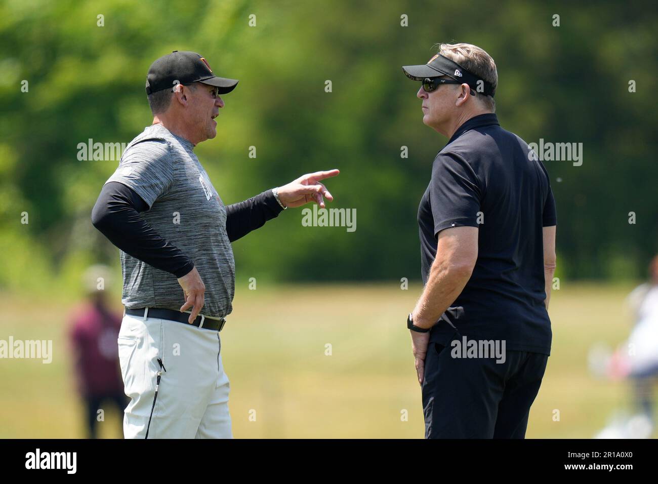 Washington Commanders head coach Ron Rivera, left, speaks with ...