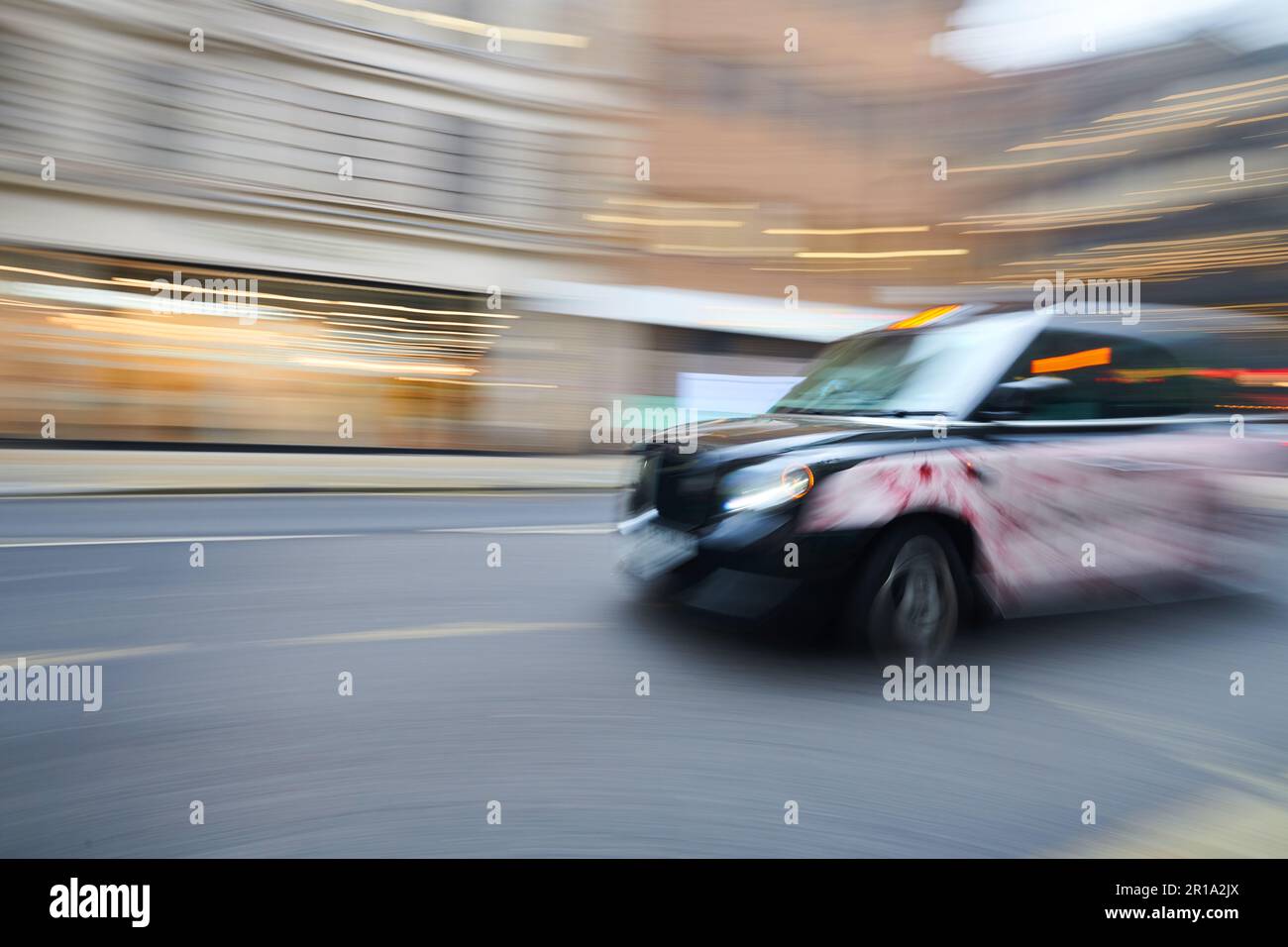 A London Black Cab driving past. Shot using a long exposure to create ...