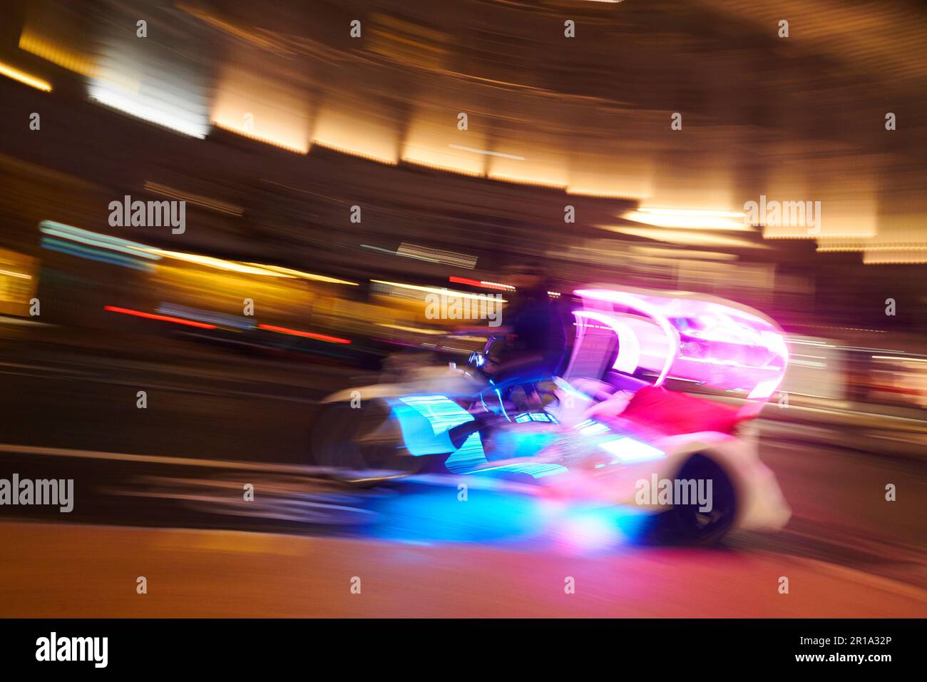 Cyclist passing by. Shot with long exposure to create motion blur and a ...