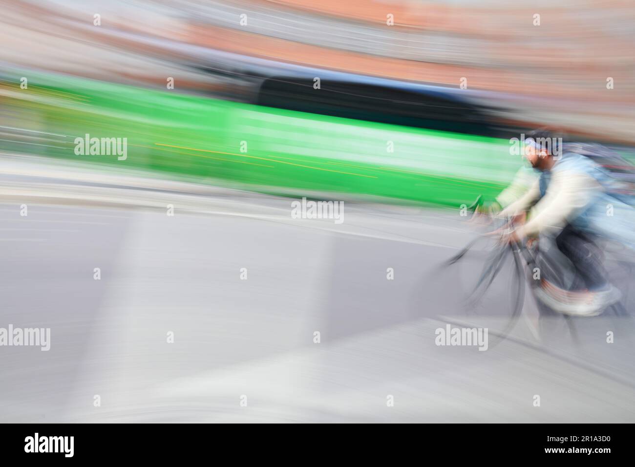 Cyclist passing by. Shot with long exposure to create motion blur and a ...