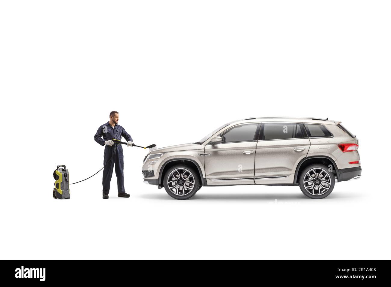 Full length shot of a worker washing a SUV with a pressure washer brush ...