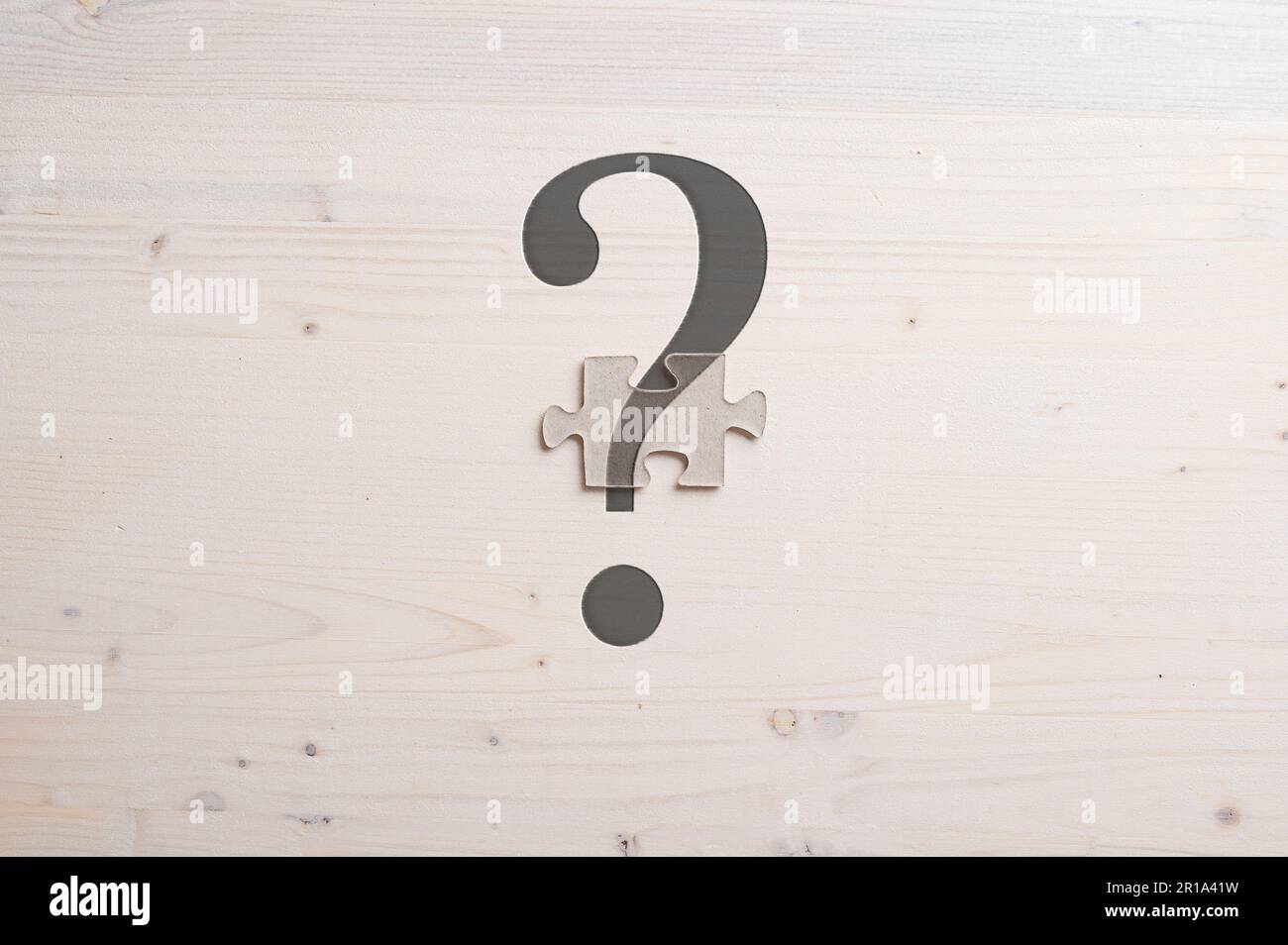 Black question mark drawn over a puzzle piece placed on simple blank ...