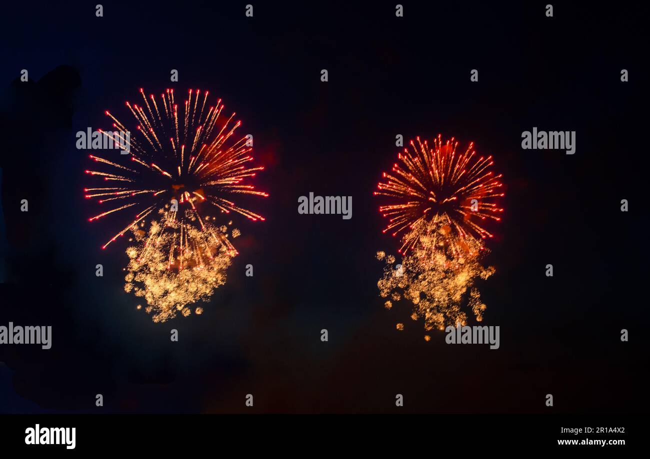 Two red fireworks and two beautiful orange fireworks in the night sky ...