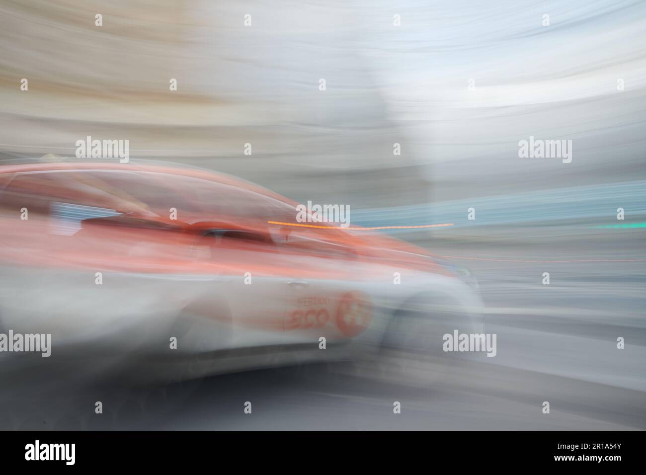 A passenger taxi passing by on the streets in the city centre. Shot ...