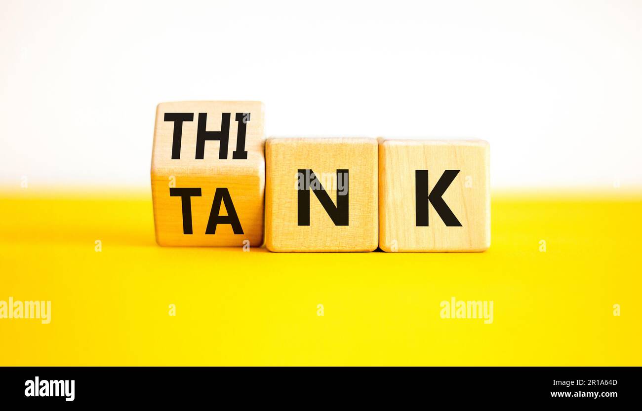 Think tank symbol. Businessman turns wooden cubes and changes the word ...