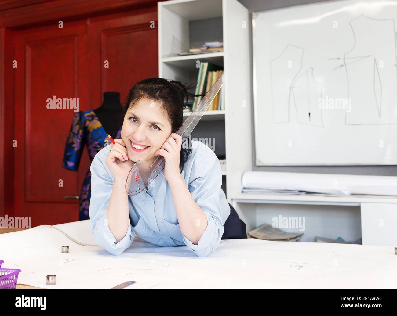 The designer-seamstress makes precise measurements for sewing clothes ...