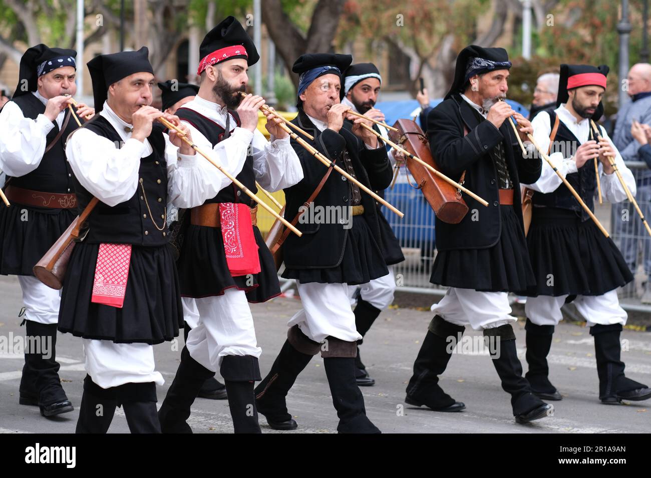 Sardinian men playing traditional wood flutes known as launeddas join ...