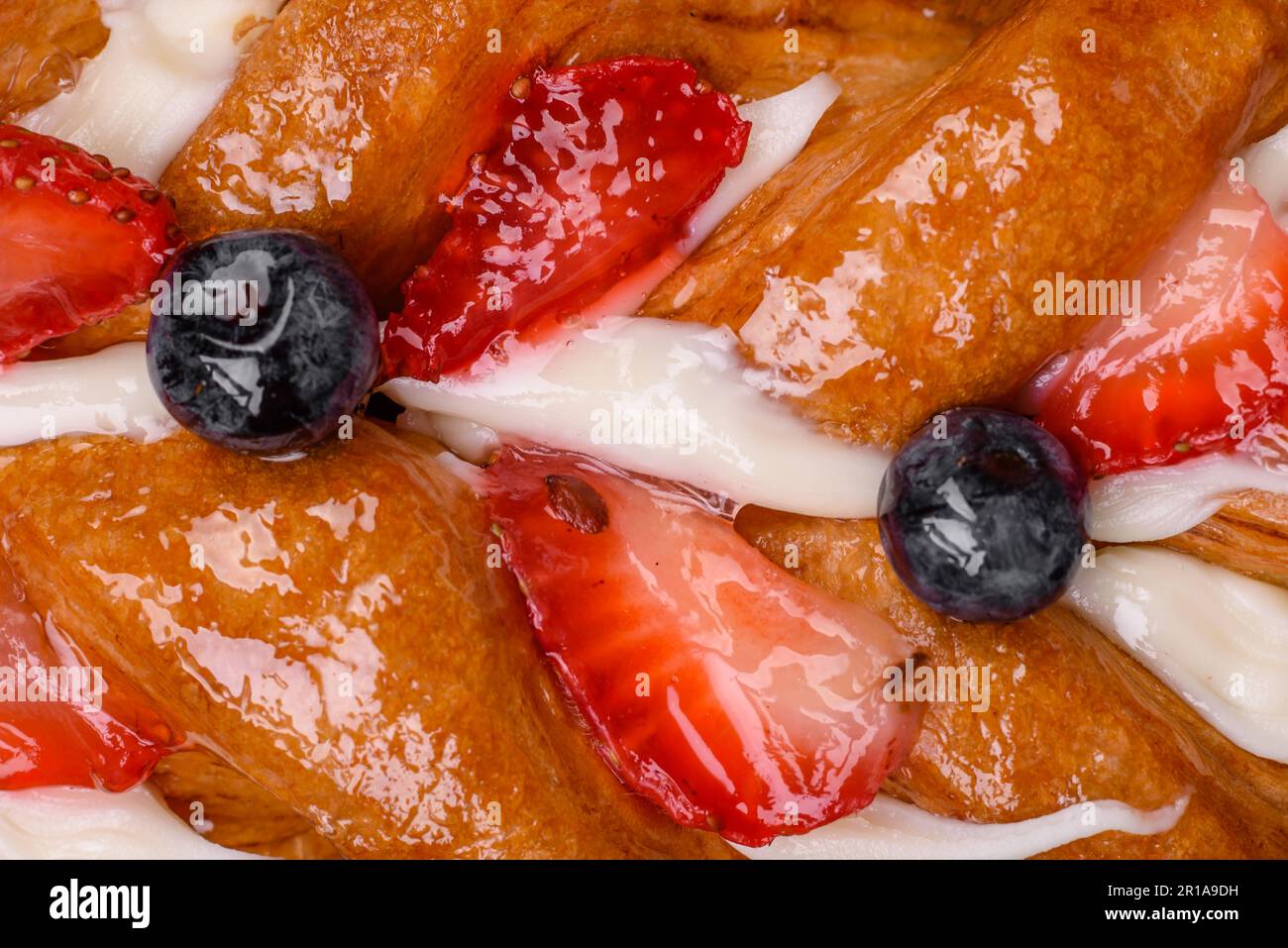 Delicious fresh crispy pastry in the form of a pigtail with ...