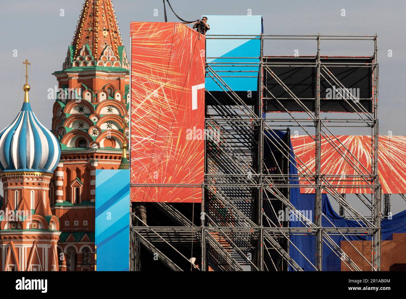 Moscow, Russia. 12th May, 2023. A worker disassembles a festive banner ...
