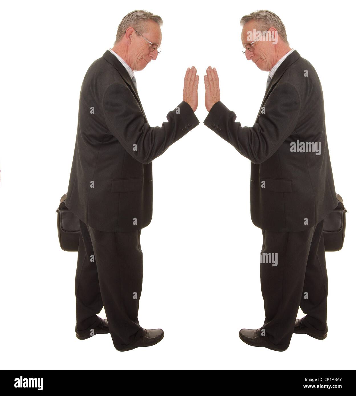 Senior businessman with a rather interesting expression congratulating ...