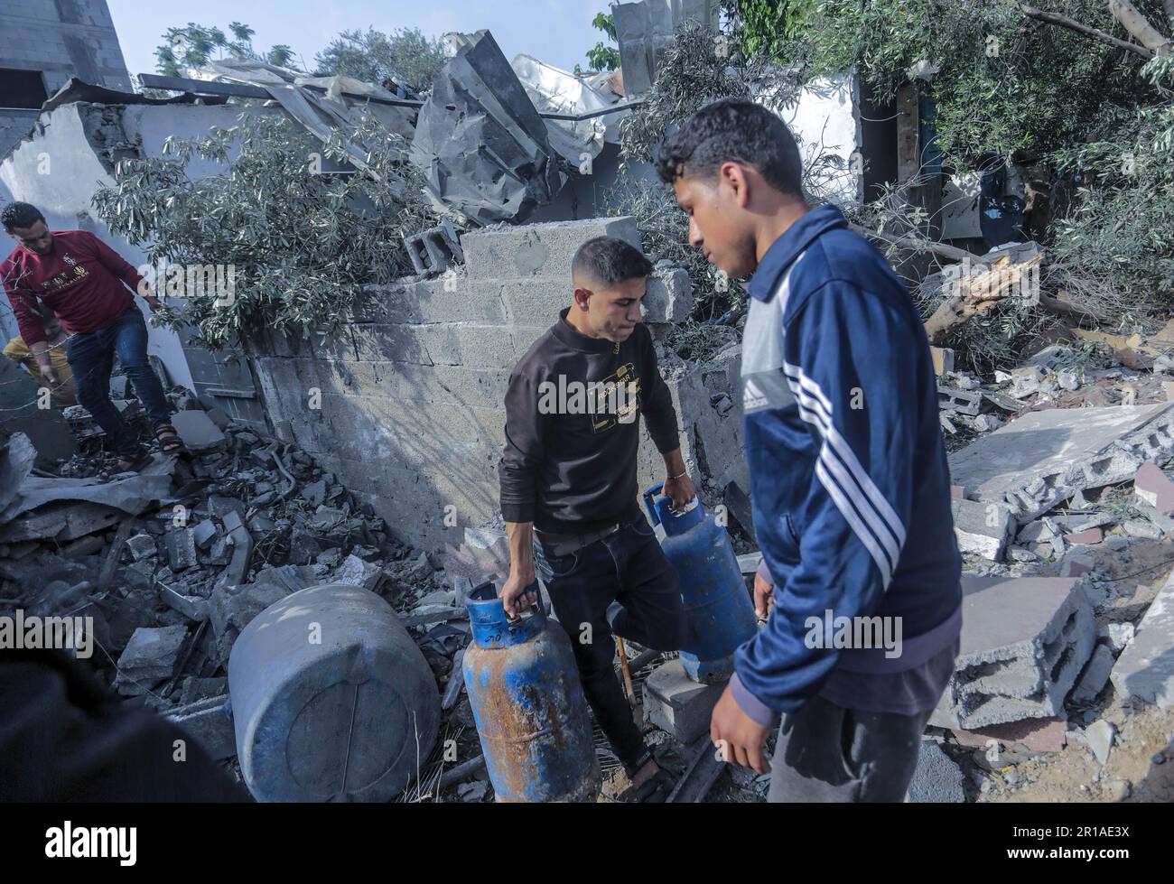 Gaza, Palestine. 12th May, 2023. Palestinians inspect the wreckage of a ...