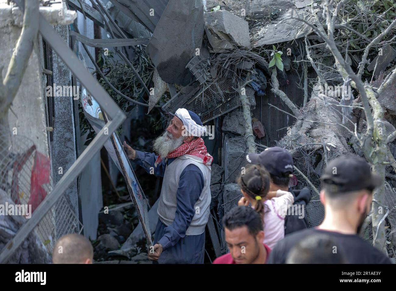 Gaza, Palestine. 12th May, 2023. Palestinians inspect the wreckage of a ...