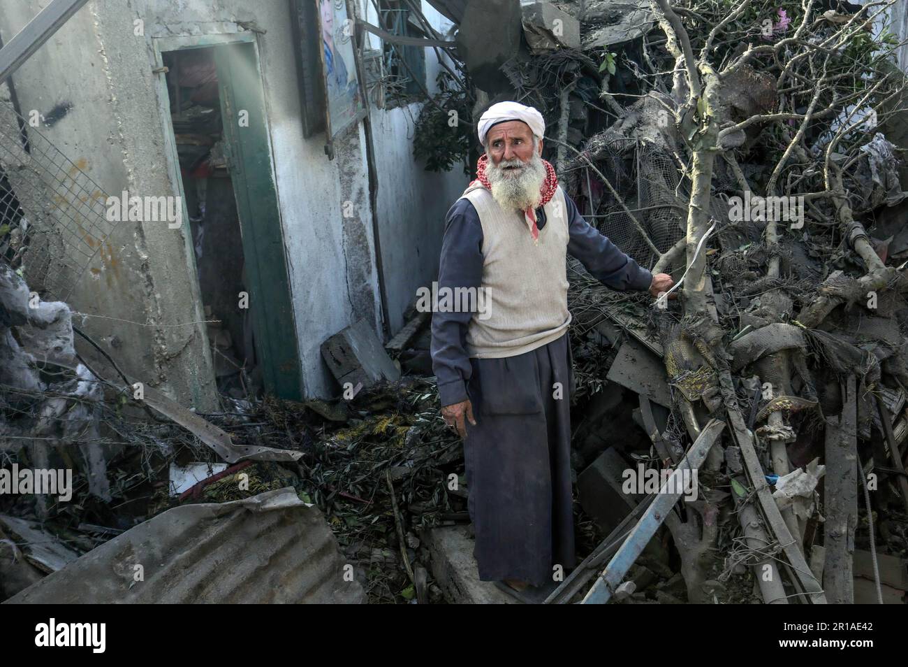 Gaza, Palestine. 12th May, 2023. A Palestinian inspects the wreckage of ...