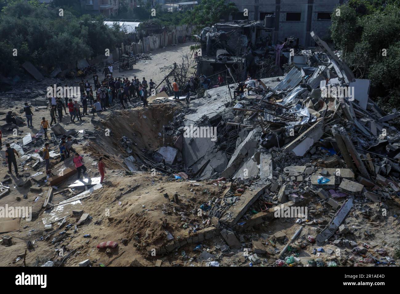Gaza, Palestine. 12th May, 2023. Palestinians inspect the wreckage of a ...