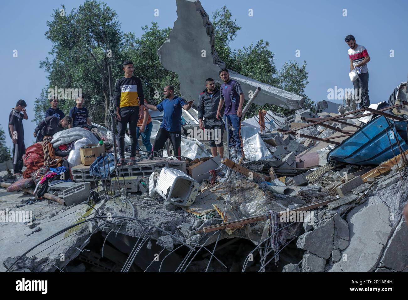 Gaza, Palestine. 12th May, 2023. Palestinians inspect the wreckage of a ...