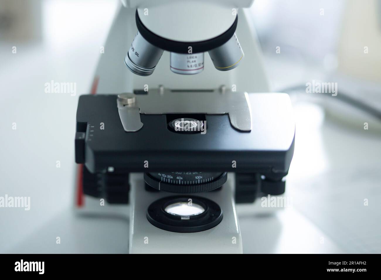 A closeup of a white microscope in a laboratory setting Stock Photo - Alamy