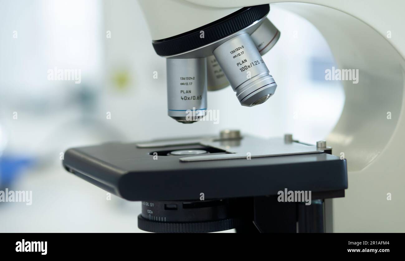 A closeup of a white microscope in a laboratory setting Stock Photo - Alamy