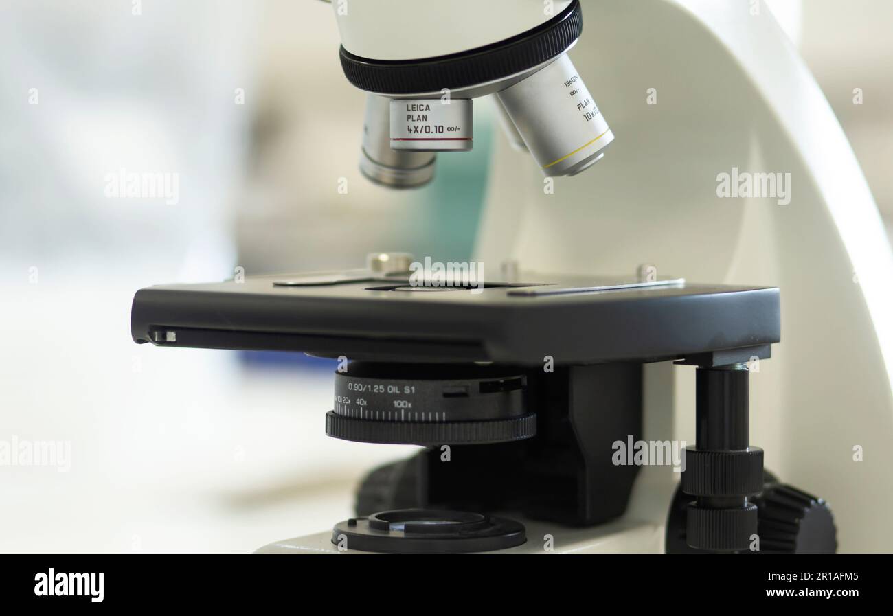A closeup of a white microscope in a laboratory setting Stock Photo - Alamy