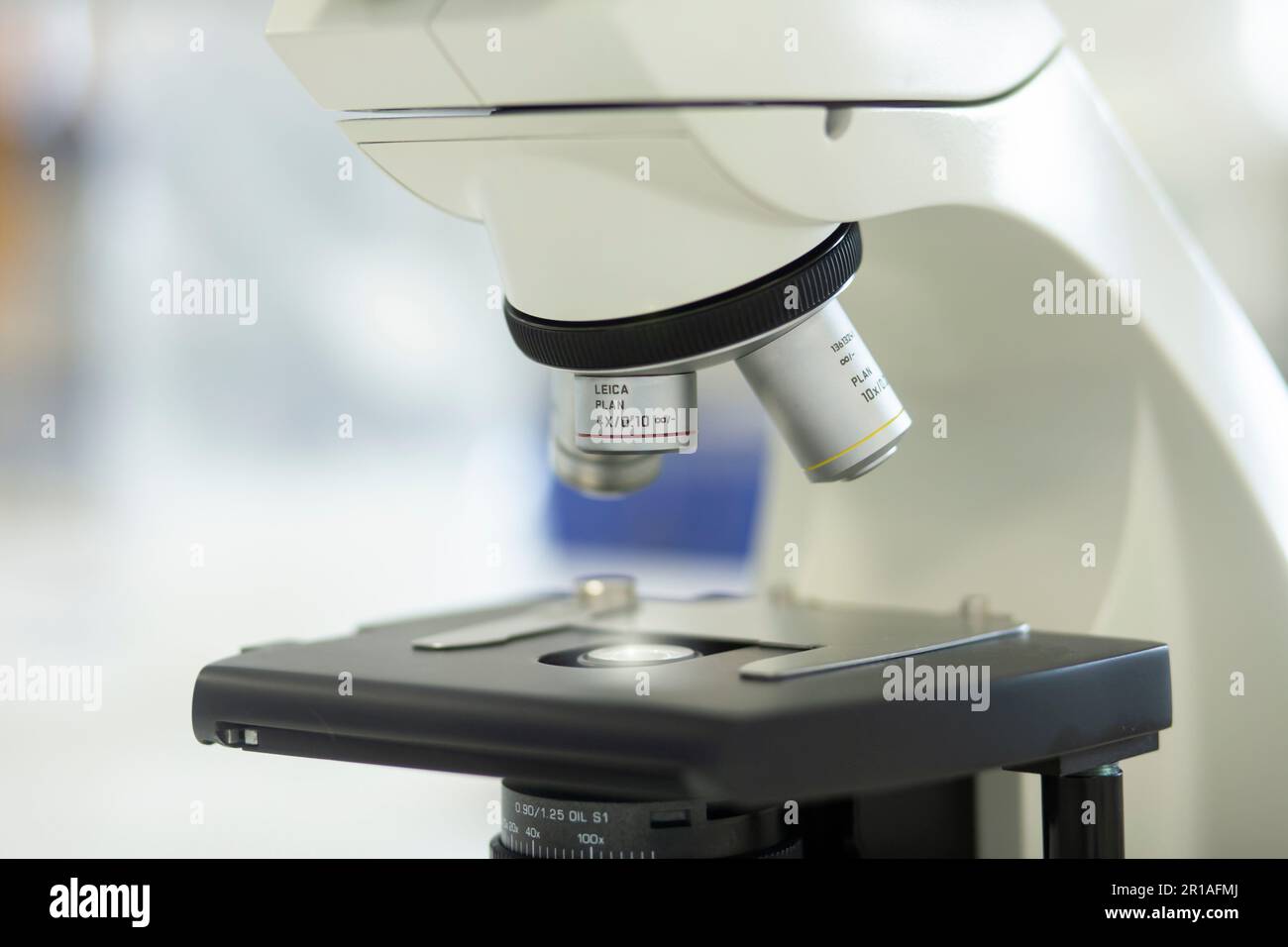A closeup of a white microscope in a laboratory setting Stock Photo - Alamy