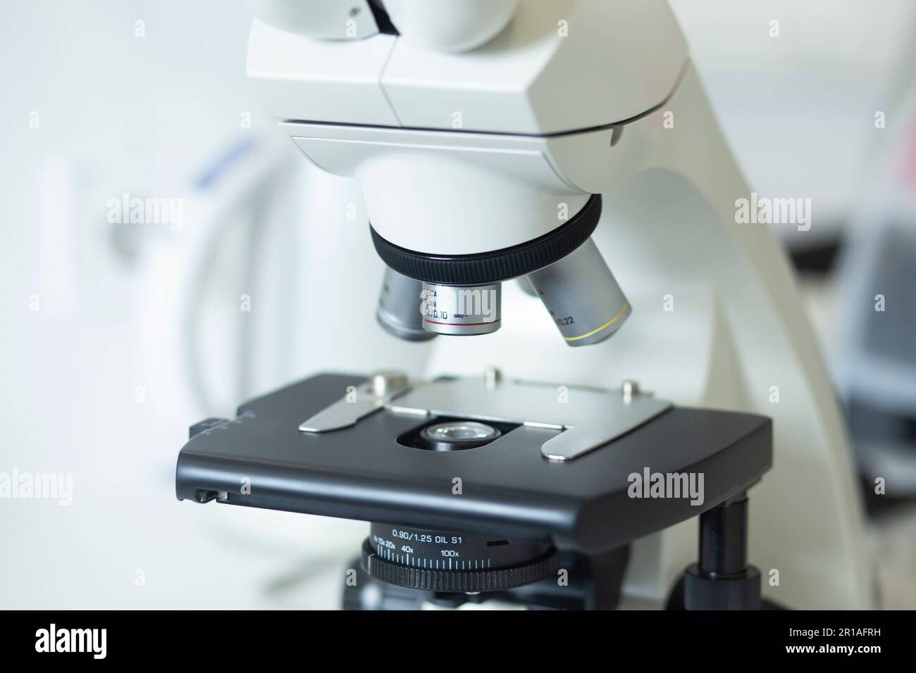 A closeup of a white microscope in a laboratory setting Stock Photo - Alamy