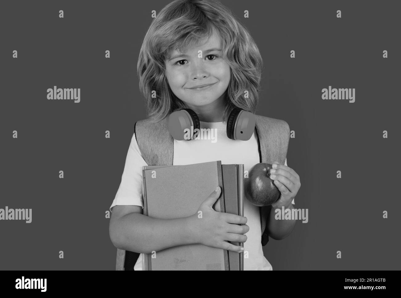 Portrait of pupil student hold book on blue isolated studio background ...