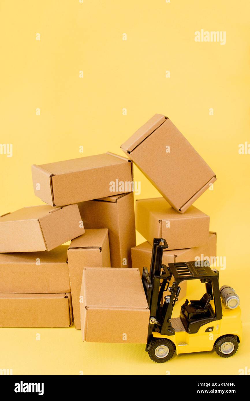 Warehouse with cardboard kraft boxes and a forklift truck. Cargo ...